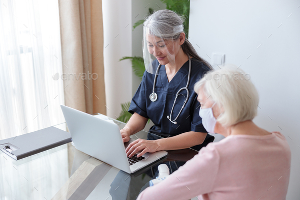 Female doctor and patient at home visit Stock Photo by KostiantynVoitenko
