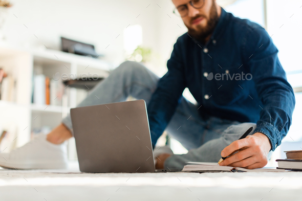 Man Taking Notes Using Laptop Sitting On Floor Indoors, Cropped Stock ...