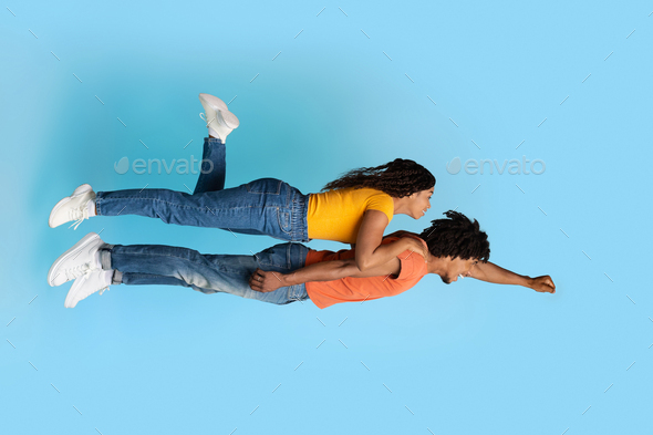 Romantic african american couple flying together in the air Stock Photo ...