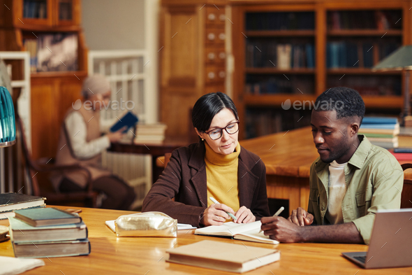 Professor Teaching in Library Stock Photo by seventyfourimages | PhotoDune