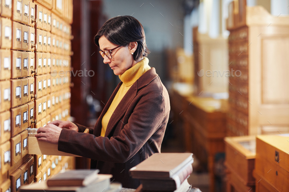 Librarian Working with Catalogue Stock Photo by seventyfourimages ...