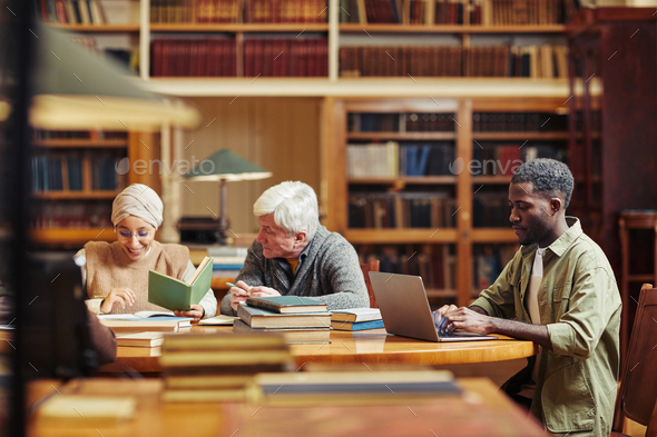 Young Man Studying in Library Stock Photo by seventyfourimages | PhotoDune