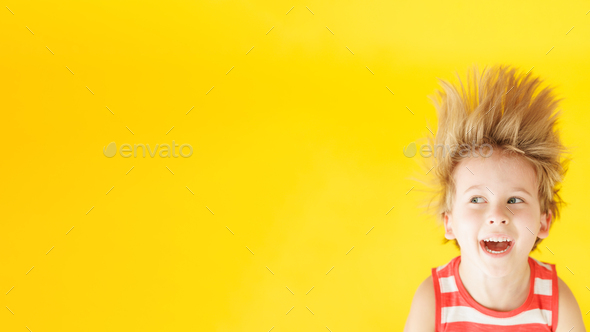 Happy child shouting against yellow paper background Stock Photo by ...