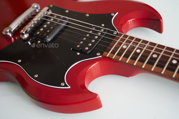 detail photo of an red electric guitar Stock Photo by Retamosastock