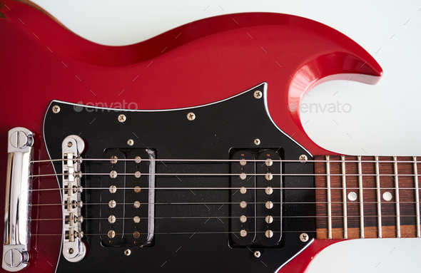 detail photo of an red electric guitar Stock Photo by Retamosastock