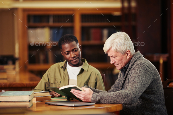 Two Men Reading in Library Stock Photo by seventyfourimages | PhotoDune