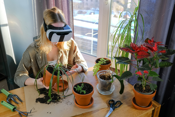 Gardening.Virtual world, metaverse.Girl planting flowers in immersive ...