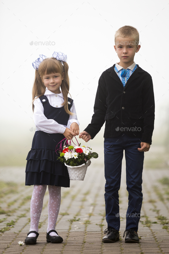 Full-length portrait of two children, serious sad boy in embroidered ...