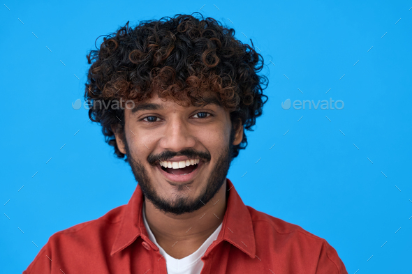 Happy young indian guy laughing isolated on blue background. Headshot ...