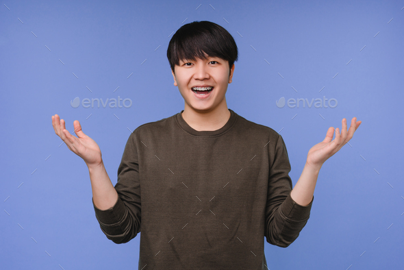 Shocked young korean asian boy man student expressing positive emotions ...