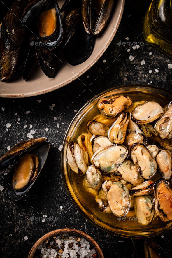 Pickled mussels in a glass bowl with spices. Stock Photo by Artem_ka2