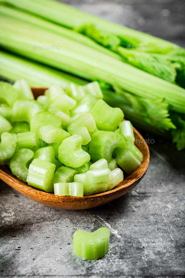 Cut into small pieces of celery in a plate. Stock Photo by Artem_ka2