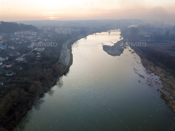 Aerial top view of river flowing through town. Rural landscape of ...