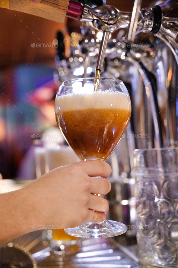 bartender tapping beer in a pub Stock Photo by CCpreset | PhotoDune