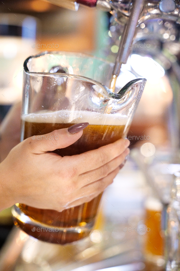 bartender tapping beer in a pub Stock Photo by CCpreset | PhotoDune