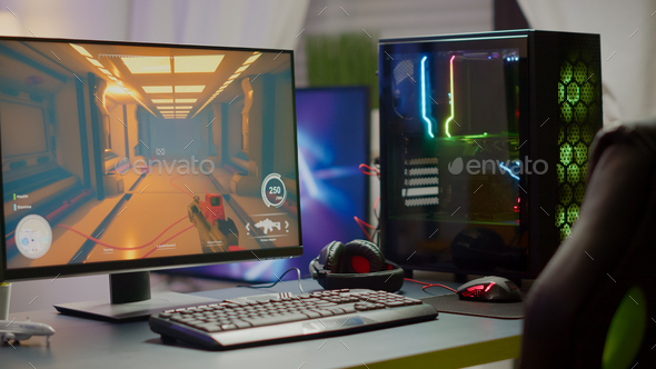 RGB powerful computer with first-person shooter game on screen Stock ...
