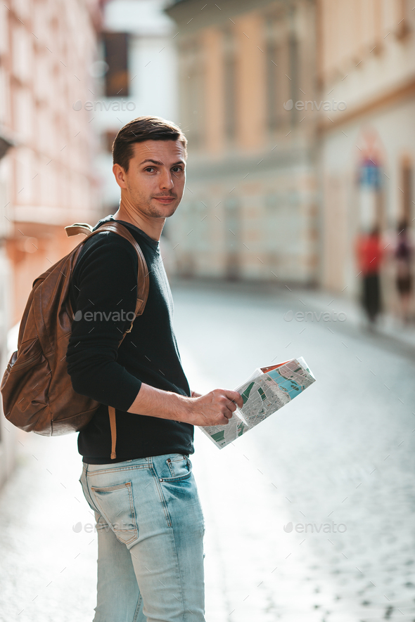 Carefree young man searching for place of destination Stock Photo by ...