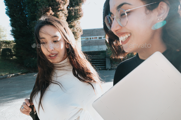 Two woman colleges rushing to get in time to class study at the ...