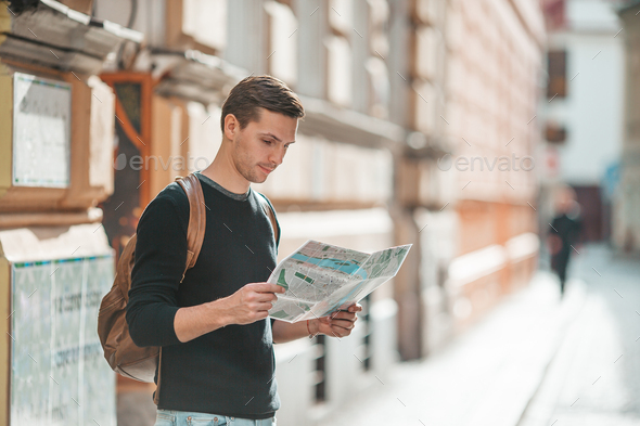 Carefree young man searching for place of destination Stock Photo by ...
