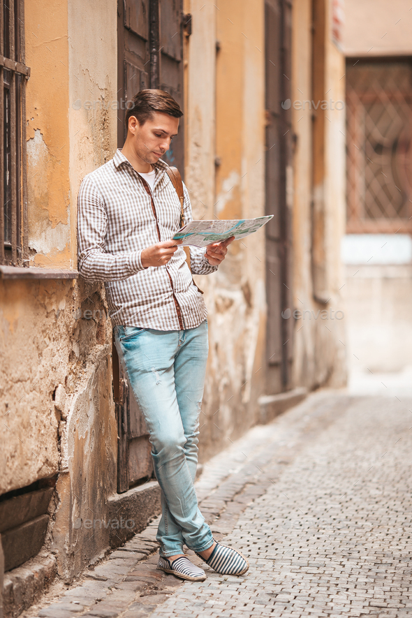Carefree young man searching for place of destination Stock Photo by ...