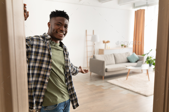 Black Man Opening Door Gesturing Inviting To Come In Indoor Stock Photo ...