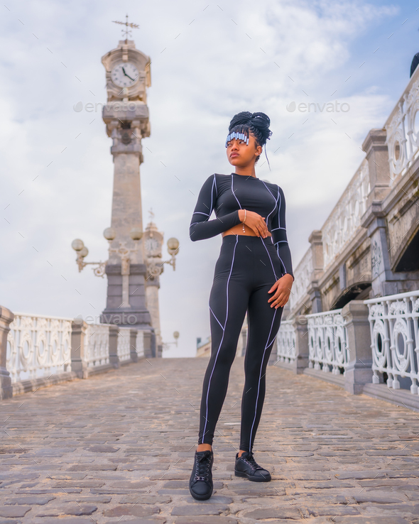 Black ethnic girl with braids with with black full body suit. Stock ...