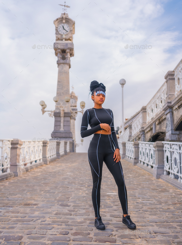 Black ethnic girl with braids with with black full body suit. Stock ...