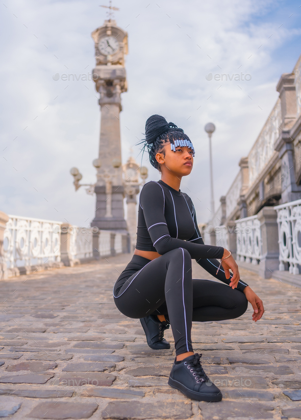 Black ethnic girl with braids with with black full body suit. Stock ...