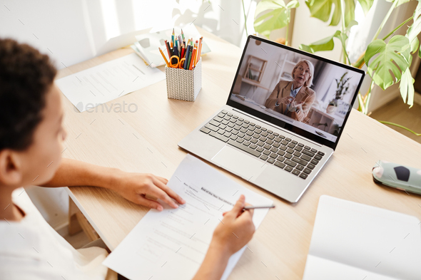 Teacher on Screen in Online Lesson Stock Photo by seventyfourimages