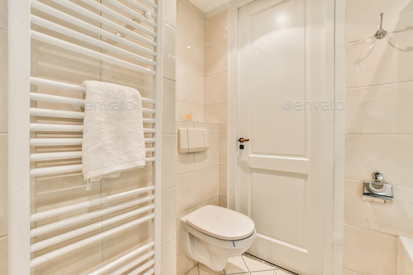 Bathroom with walls of flesh-colored tiles Stock Photo by pro_creator
