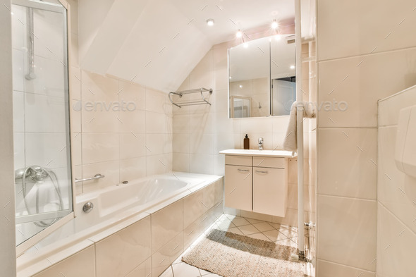 Bathroom with walls of flesh-colored tiles Stock Photo by pro_creator