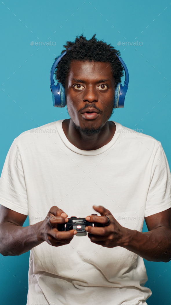 African american gamer playing video games with controller Stock Photo ...