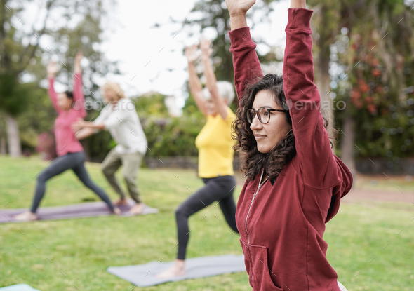 Multi generational people doing yoga exercise at park - Healthy life ...