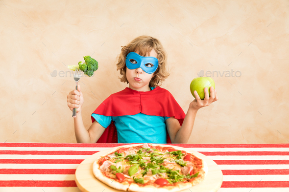 Superhero child eating superfood Stock Photo by Sunny_studio | PhotoDune