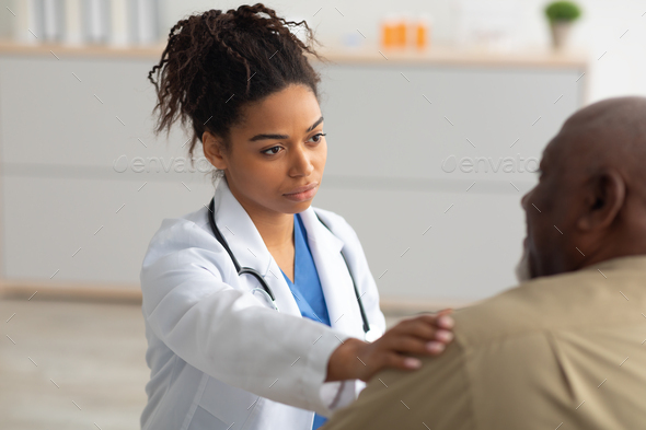 Close up of black female doctor tapping patting patient's shoulder ...