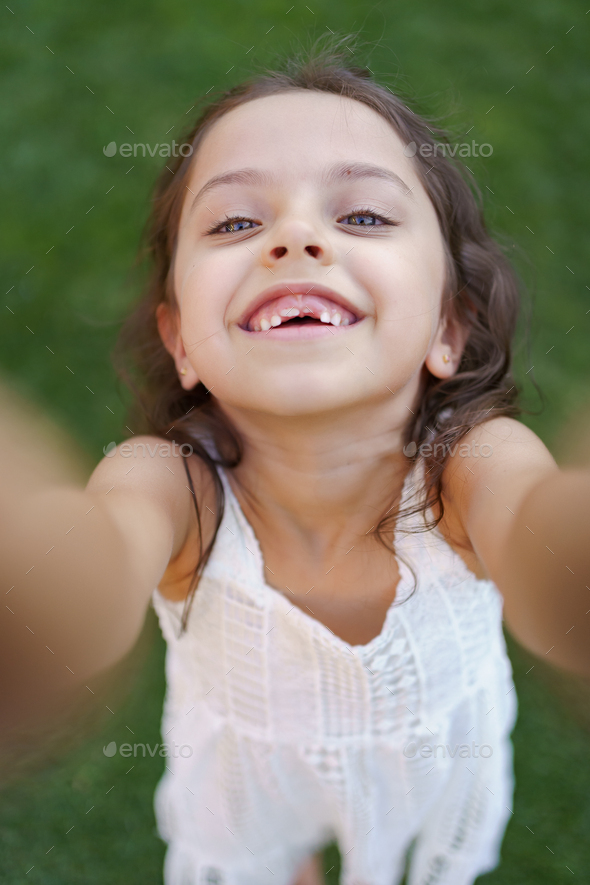 Lovely smiling little girl top view potrait Stock Photo by diignat