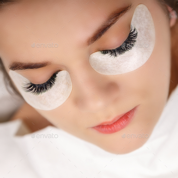Eyelash Extension Procedure. Woman Eye with Long Eyelashes. Close up ...