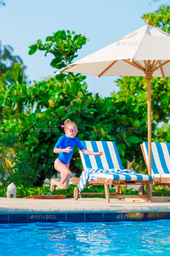 Funny cute little girl in outdoor swimming pool Stock Photo by ...