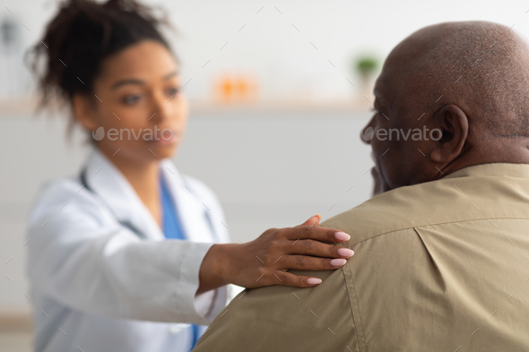 Close up of black female doctor tapping patting patient's shoulder ...