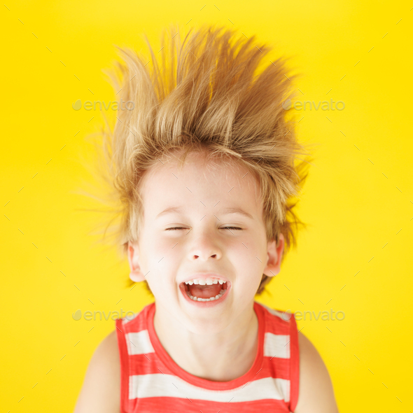 Happy child shouting against yellow paper background Stock Photo by ...