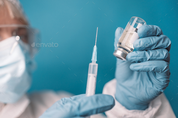 taking covid vaccination booster shot or 3rd dose from syringe. Stock ...
