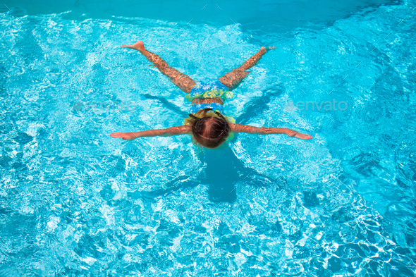 Little cute happy girl swimming in outdoor pool like a star Stock Photo ...
