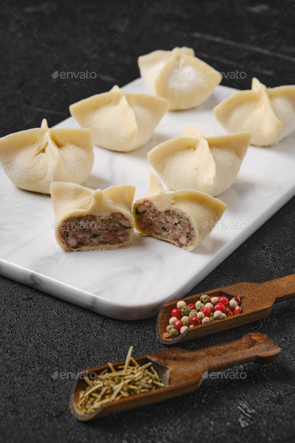 Spicy beef dumplings on marble serving plate Stock Photo by boomeart