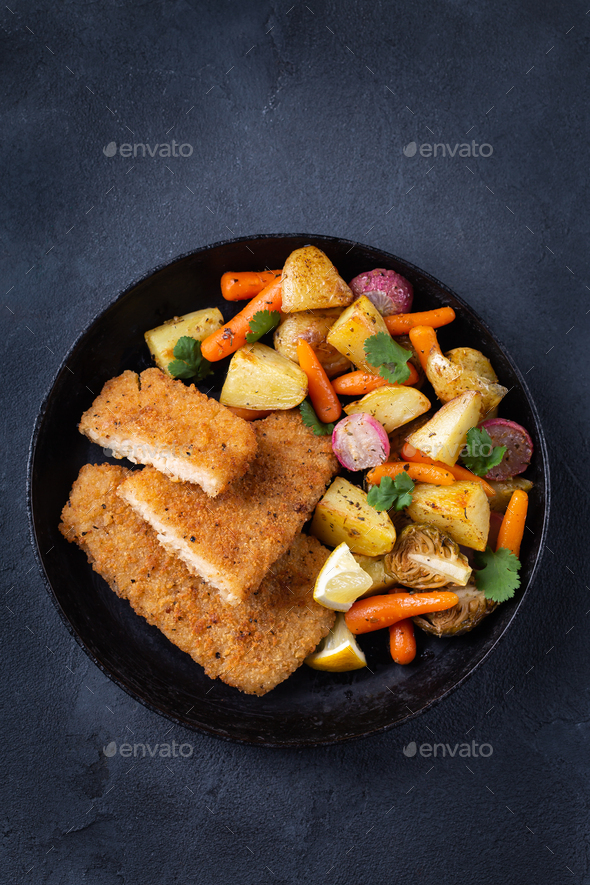 Vegan Plant based fish with crispy batter and roasted vegetables Stock ...