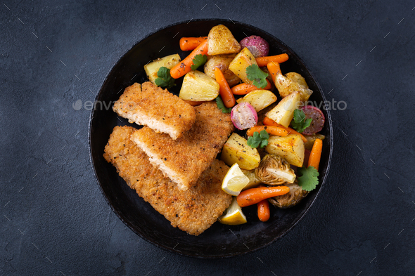Vegan Plant based fish with crispy batter and roasted vegetables Stock ...