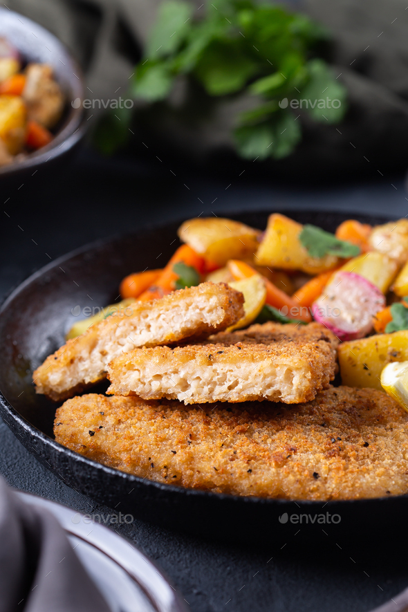 Vegan Plant based fish with crispy batter and roasted vegetables Stock ...