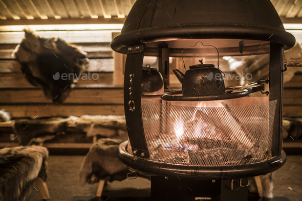 Boiling a tea pot on an open log fire in a hut in the forest in Finnish ...