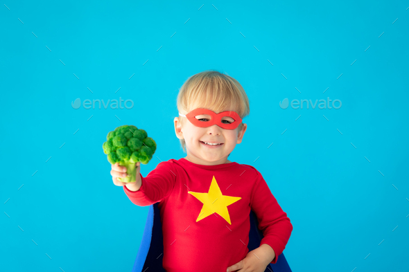 Superhero child holding broccoli Stock Photo by Sunny_studio | PhotoDune