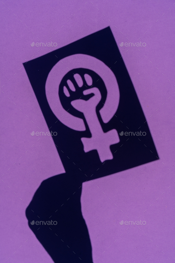 Symbol of the struggle of feminism on a purple background Stock Photo ...
