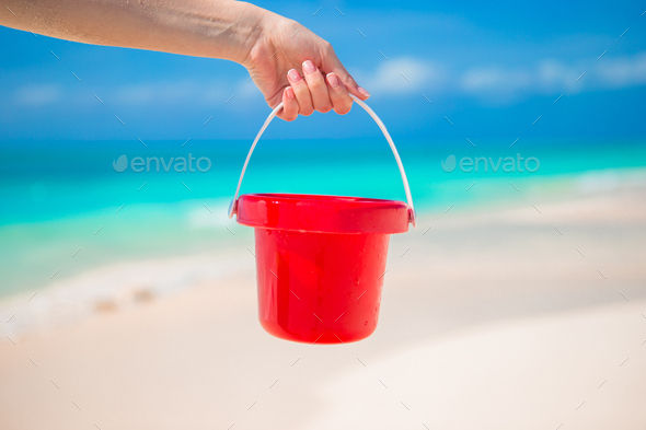 Close up hand holding a small red bucket on tropical beach Stock Photo ...